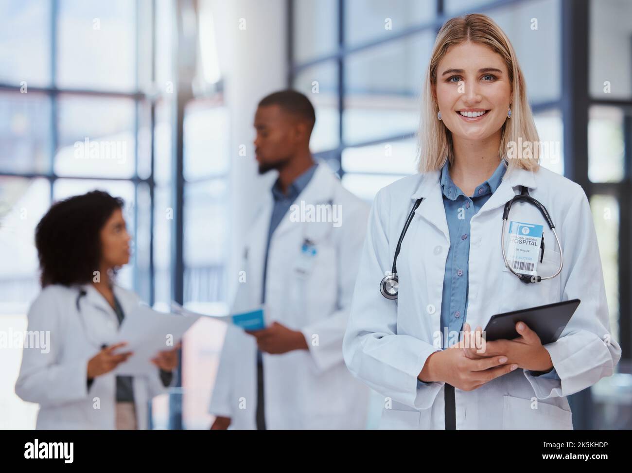 Woman, team and portrait of doctor with tablet in the hospital. Female ...