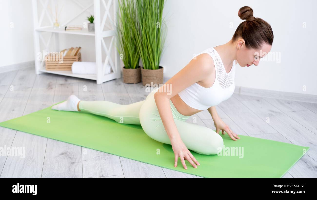 yoga stretch fitness wellbeing woman exercise gym Stock Photo - Alamy