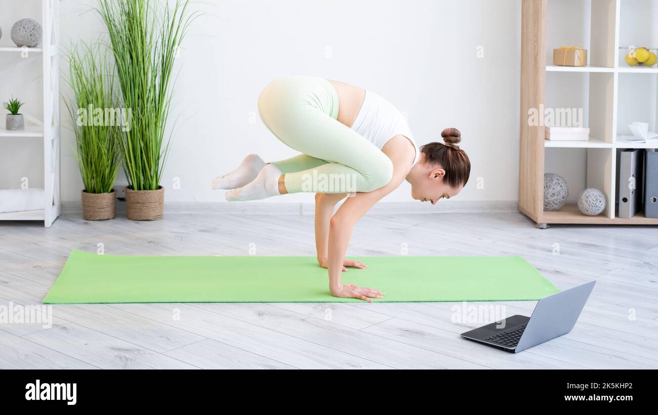 yoga lesson online pilates exercise woman home Stock Photo - Alamy