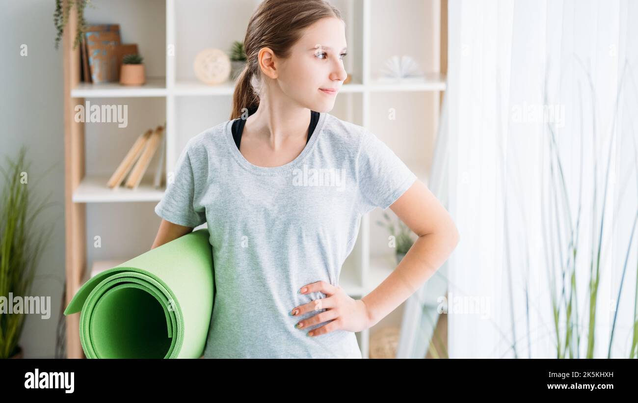 home fitness active kids girl yoga practice mat Stock Photo - Alamy