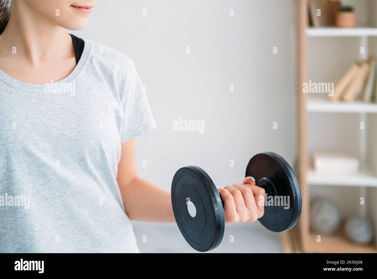 home exercise child fitness girl dumbbell training Stock Photo - Alamy