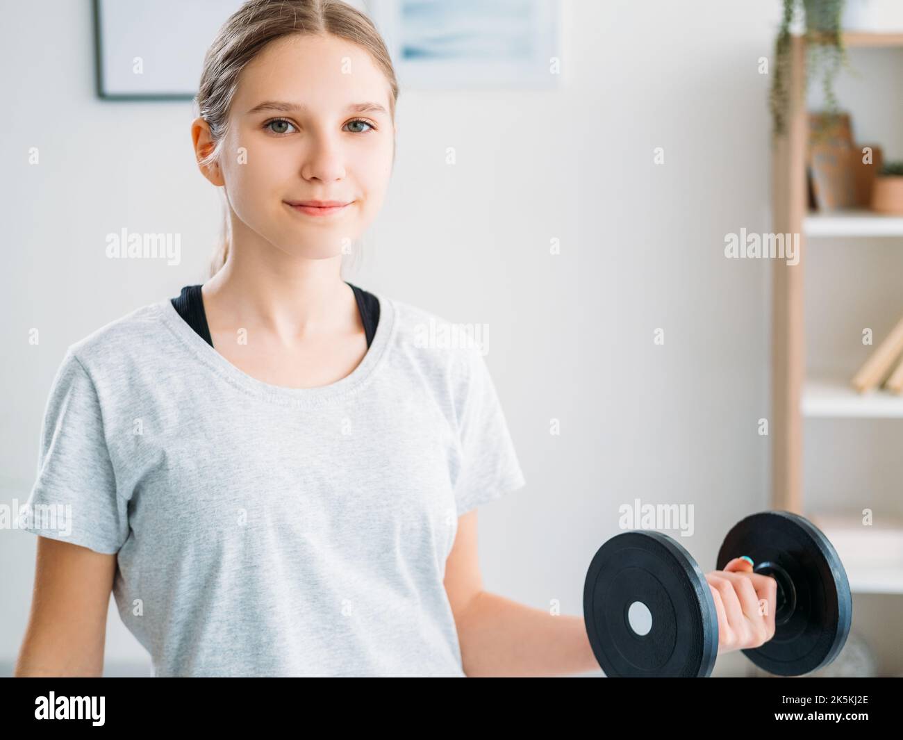 child home sport girl training arm with dumbbell Stock Photo - Alamy