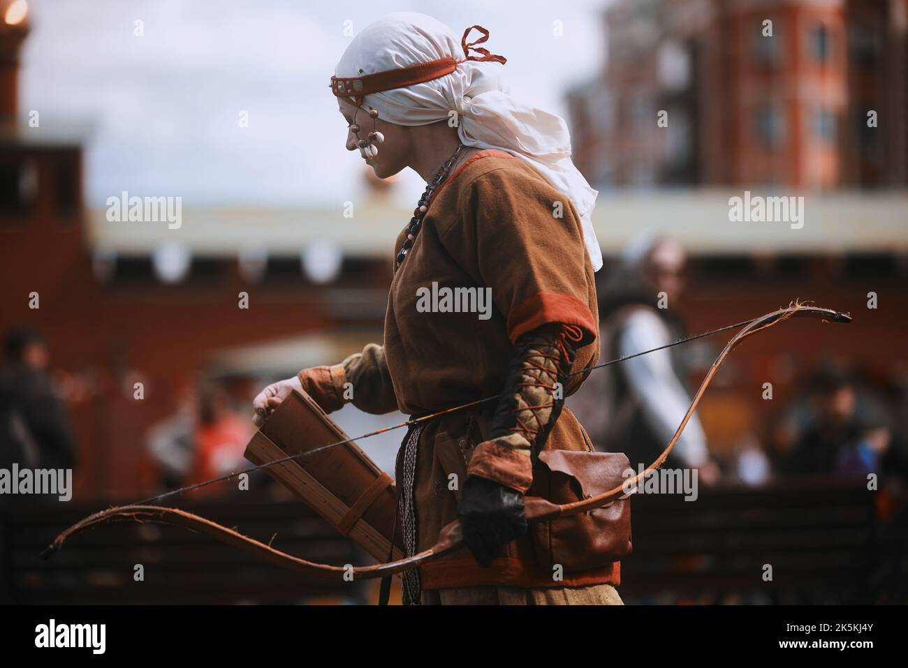 Medieval archery tournament. A woman shoots an arrow in the medieval ...