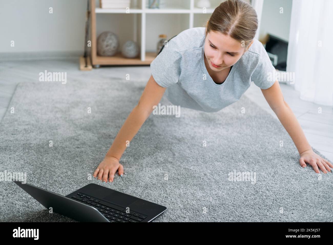 online sport kid home fitness girl laptop exercise Stock Photo - Alamy