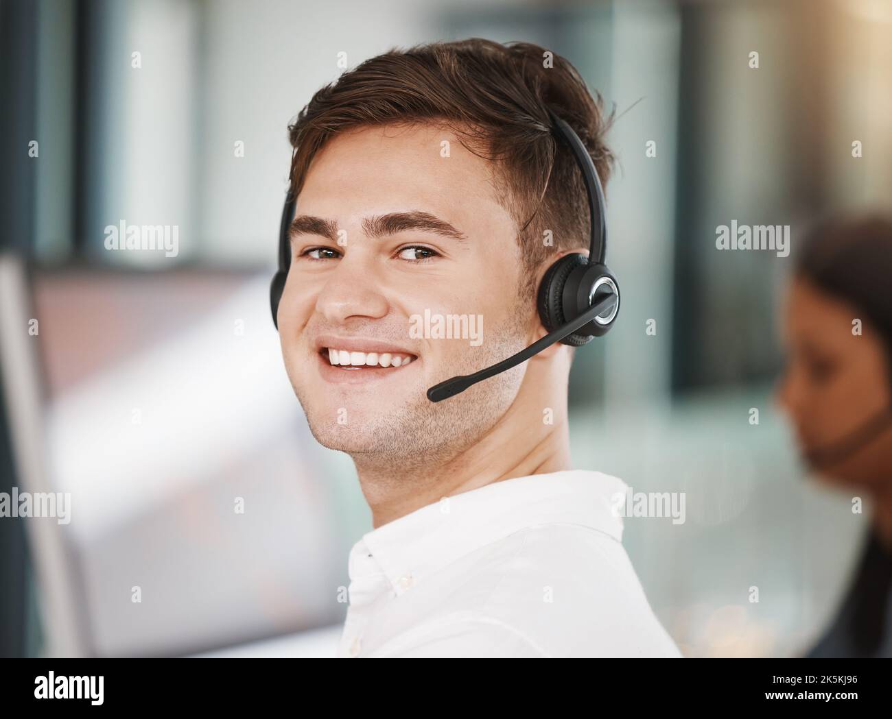 Portrait of a call center consultant working in an office doing a crm ...