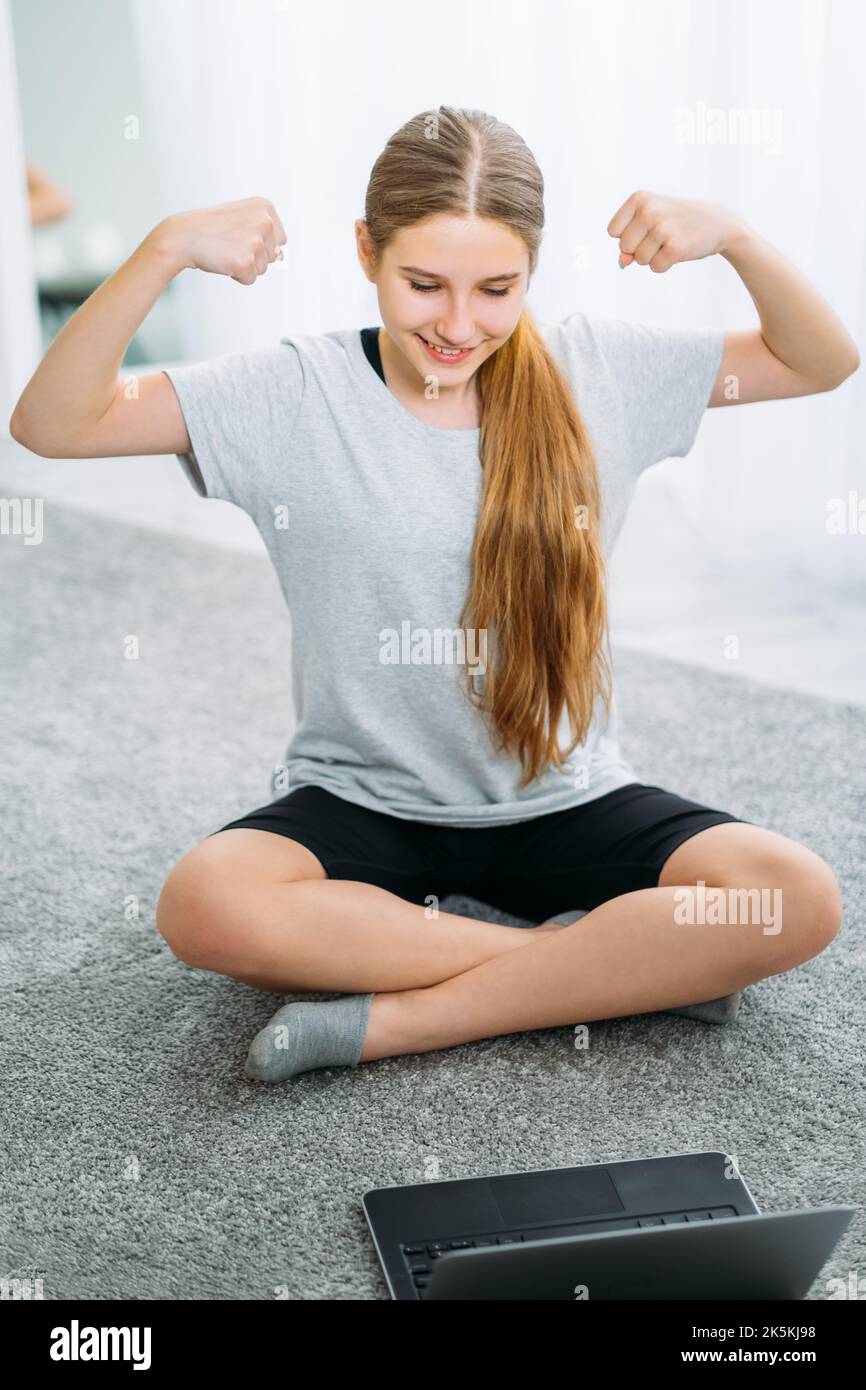 kids online sport home training strong girl laptop Stock Photo - Alamy