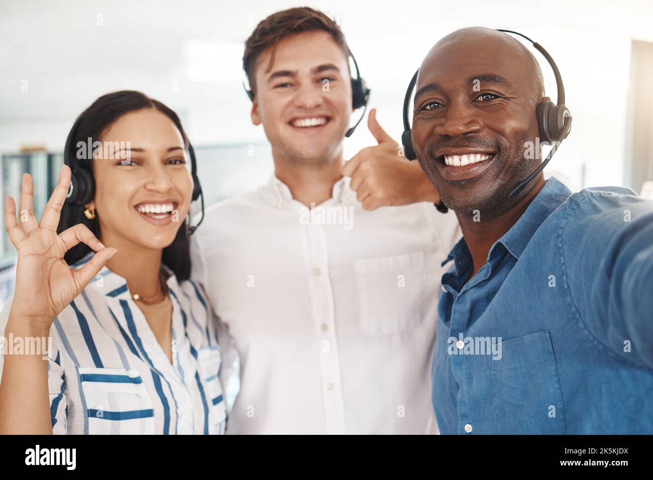 Woman, men and selfie of call center agents with headset, thumbs up and ...