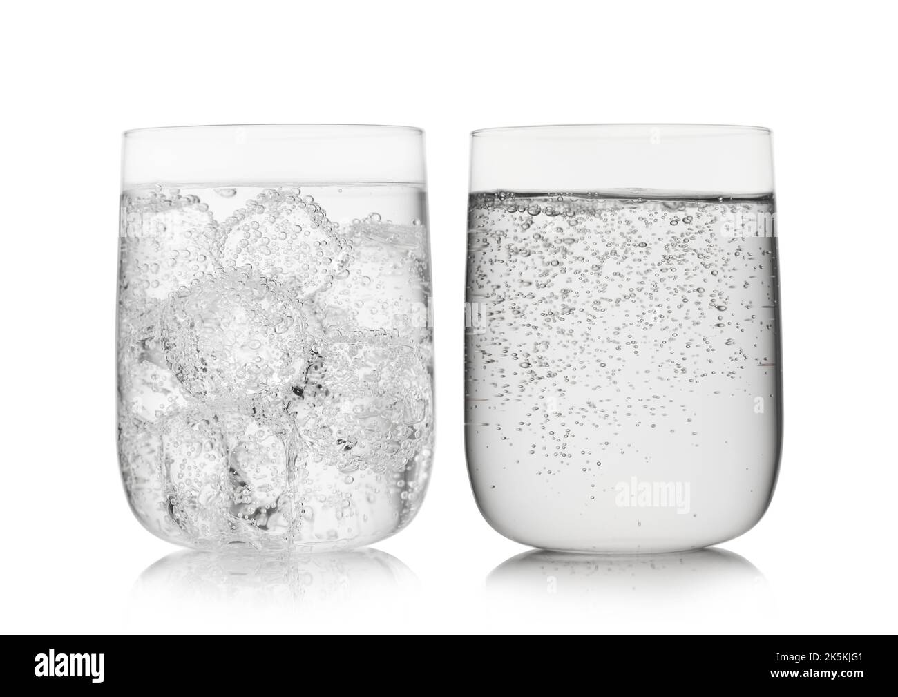 Sparkling natural mineral water with ice cubes in large glasses on white background Stock Photo ...