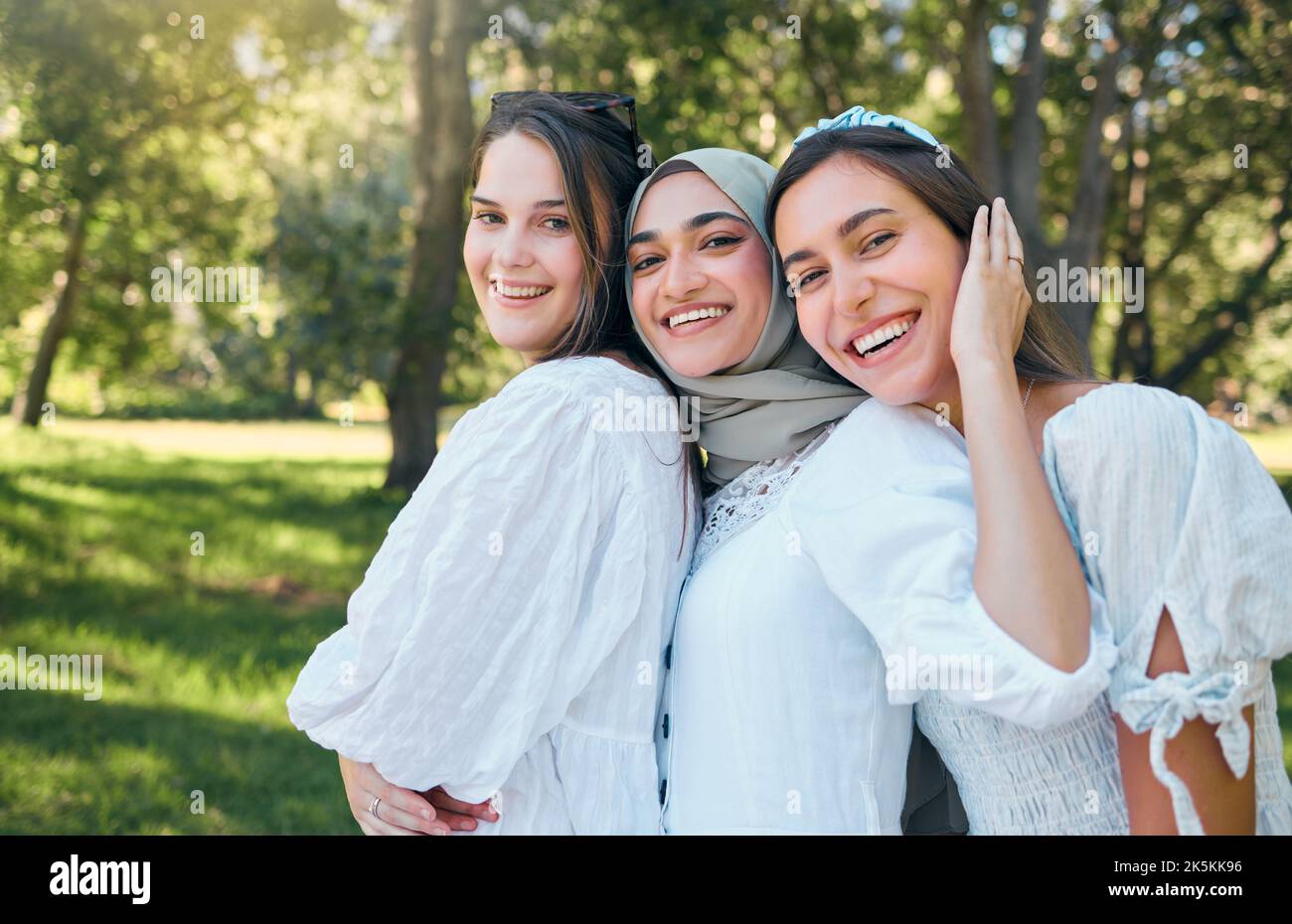Friends, diversity and freedom with women in park and hug together for ...