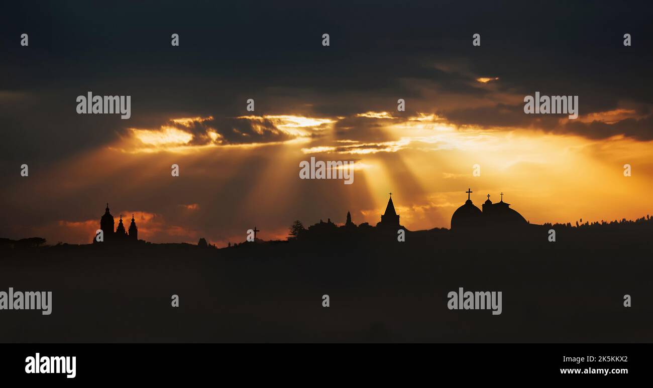 Rays of light shining through dark clouds over Jerusalem city ...