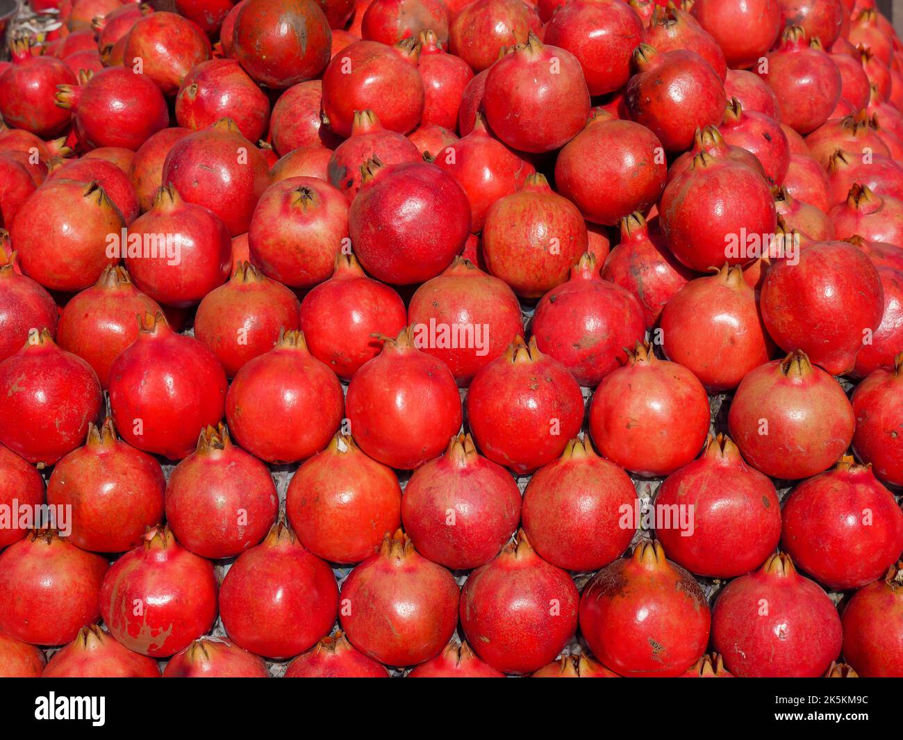 Pile of pomegranate. Heap of ripe whole pomegranates, ready to sell in ...