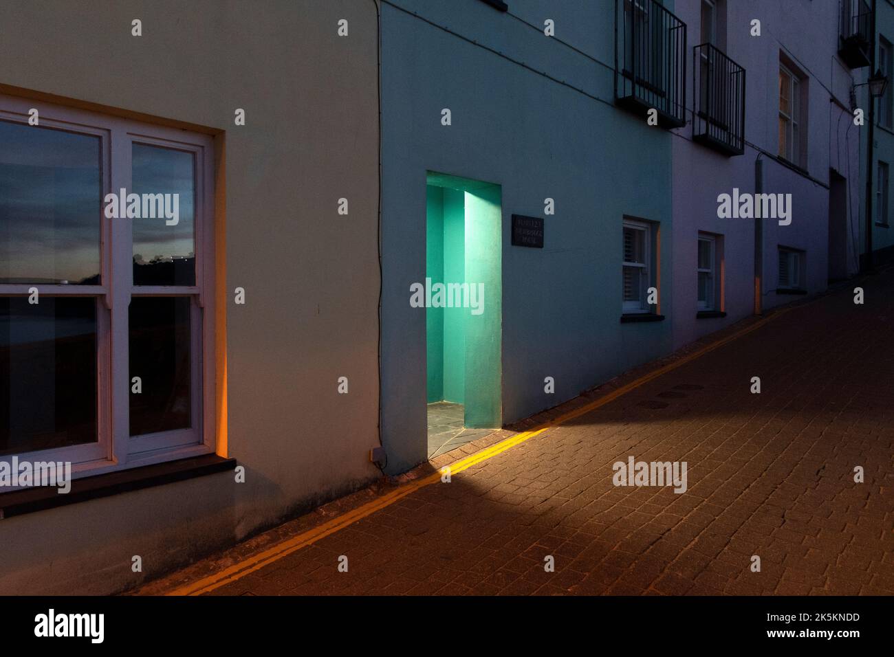 Quiet streets in Tenby after closing time, illuminated from inside the ...