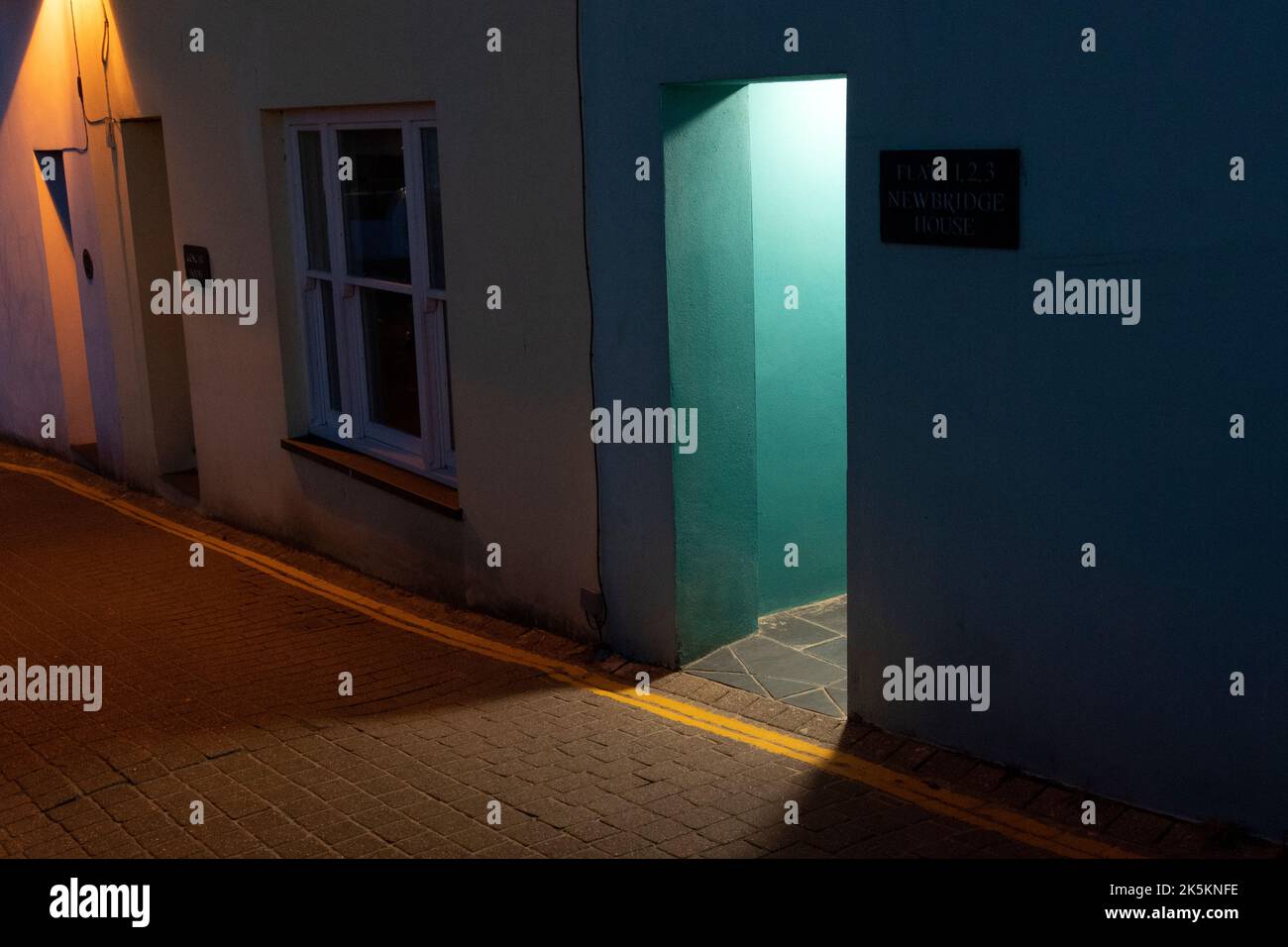 Quiet streets in Tenby after closing time, illuminated from inside the ...