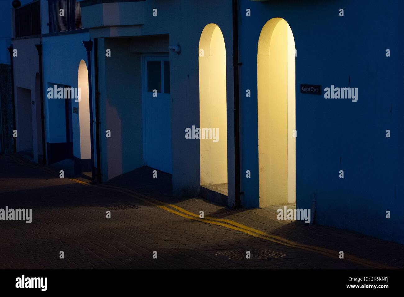 Quiet streets in Tenby after closing time, illuminated from inside the ...