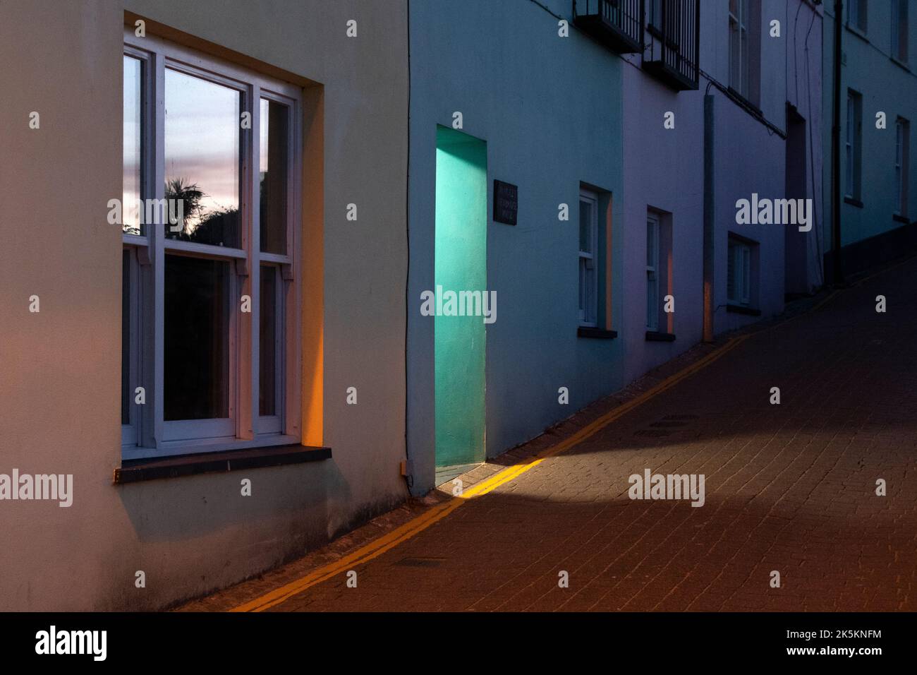 Quiet streets in Tenby after closing time, illuminated from inside the ...