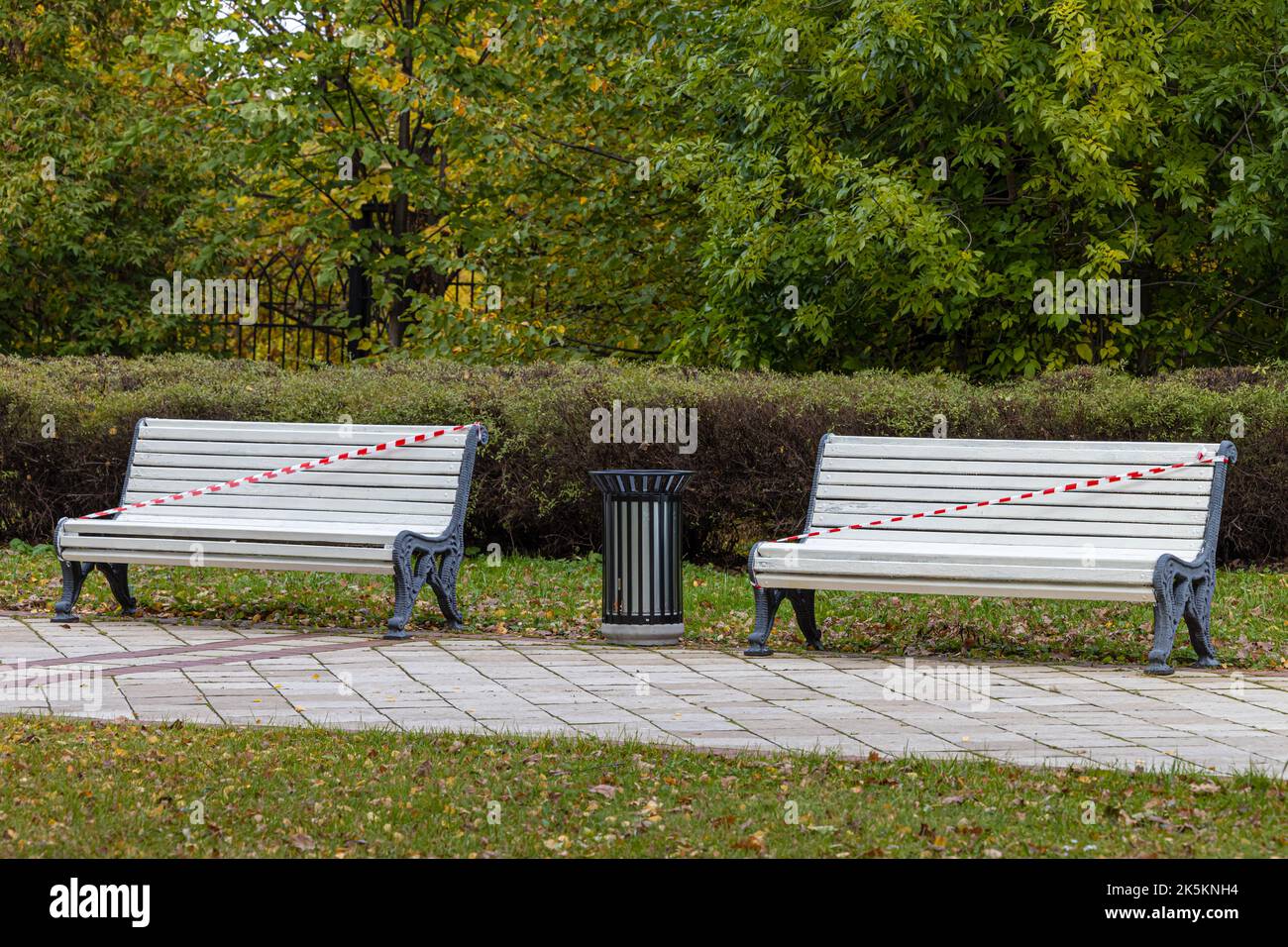 painted empty park bench with red ribbon. bench after painting Stock ...