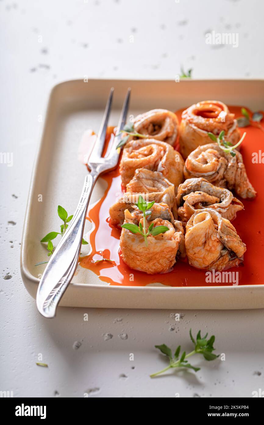 Homemade and tasty marinated rollmops with onions. Fish marinated with ...