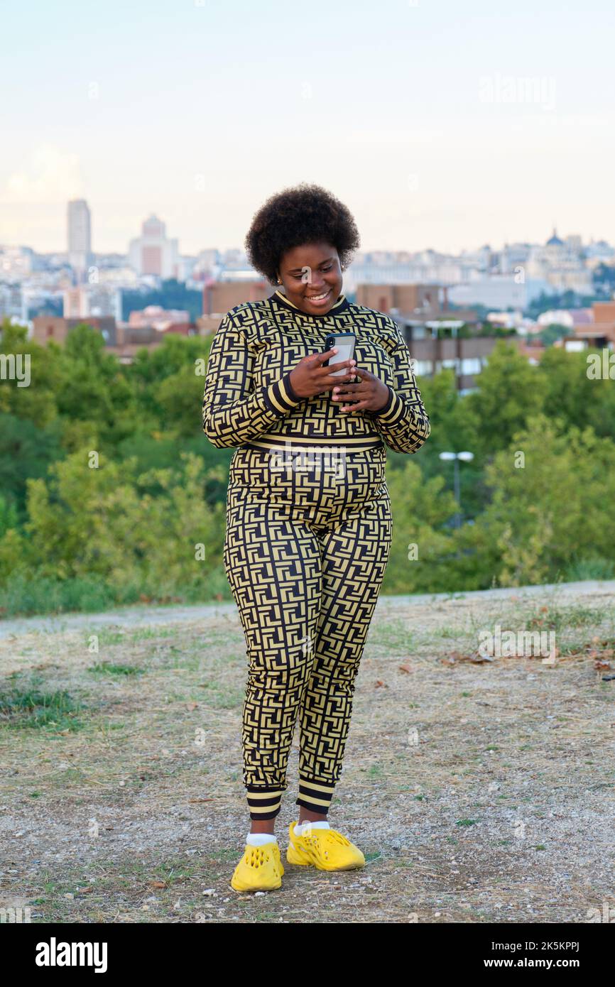 Young African woman using the smartphone at street Stock Photo - Alamy