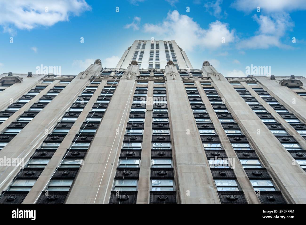 Rising up facade of a skyscraper in a classical style with bas-reliefs ...