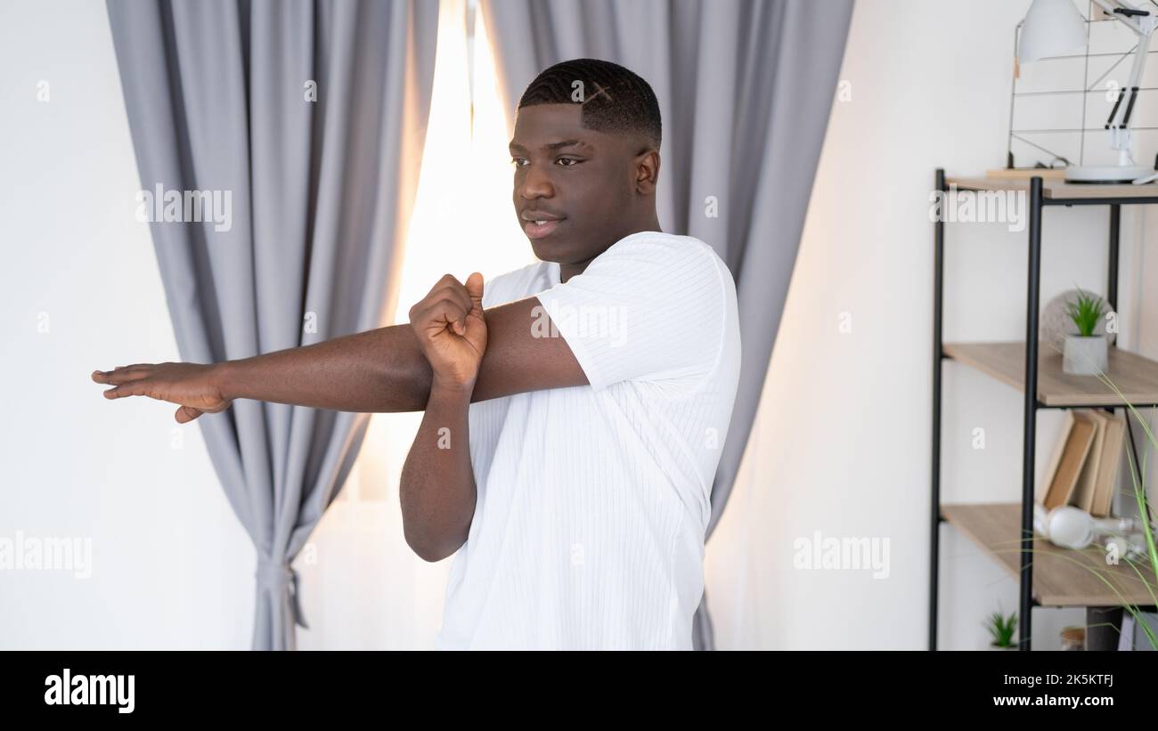 stretching exercise black man home sport healthy Stock Photo - Alamy