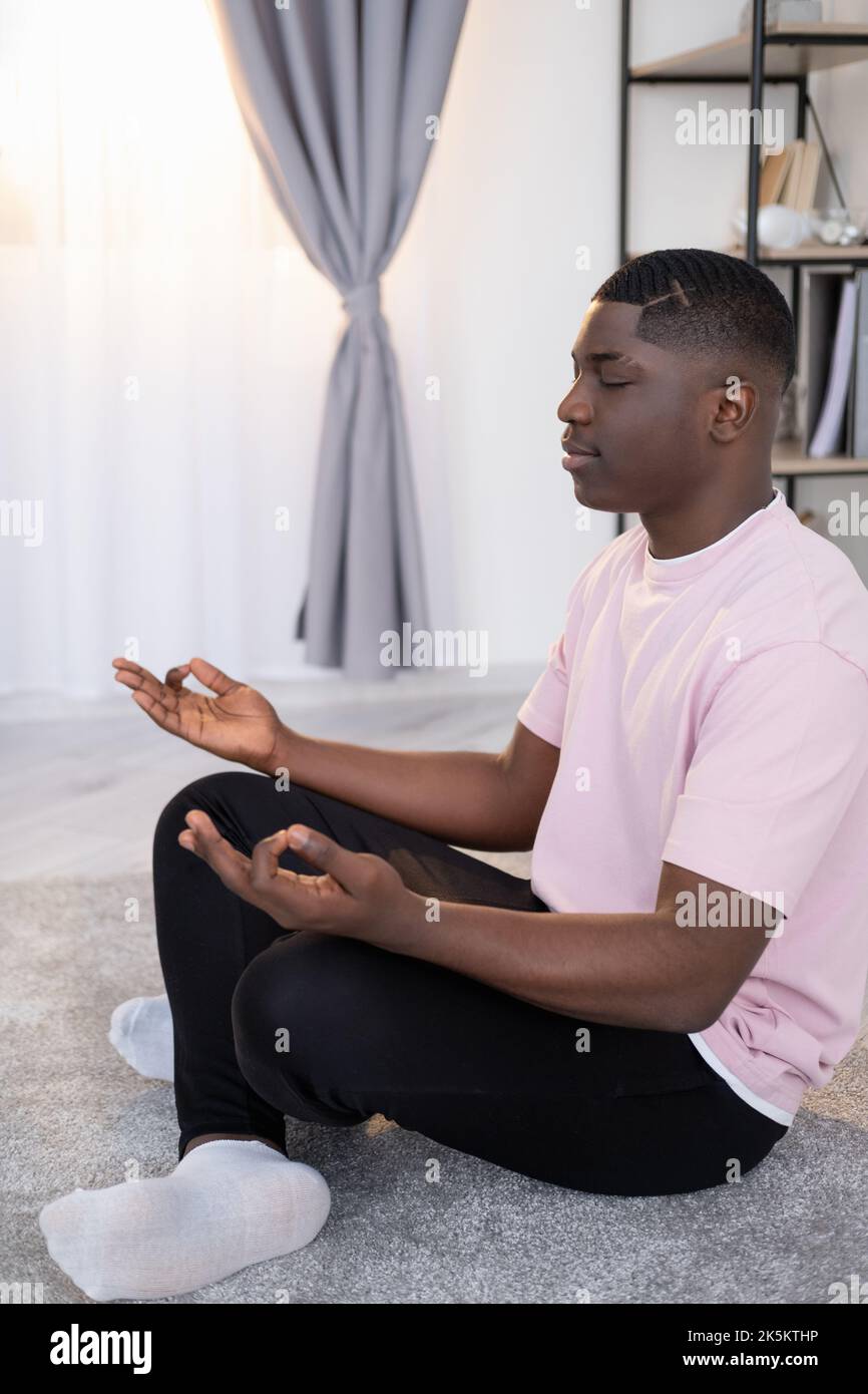 find harmony peaceful black man home yoga training Stock Photo - Alamy