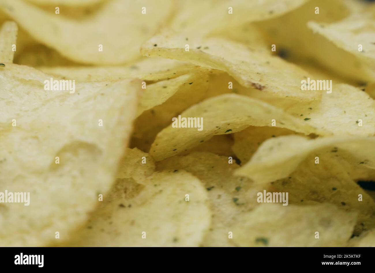 Potato chips on a rotating surface. Close-up. Food Stock Photo - Alamy