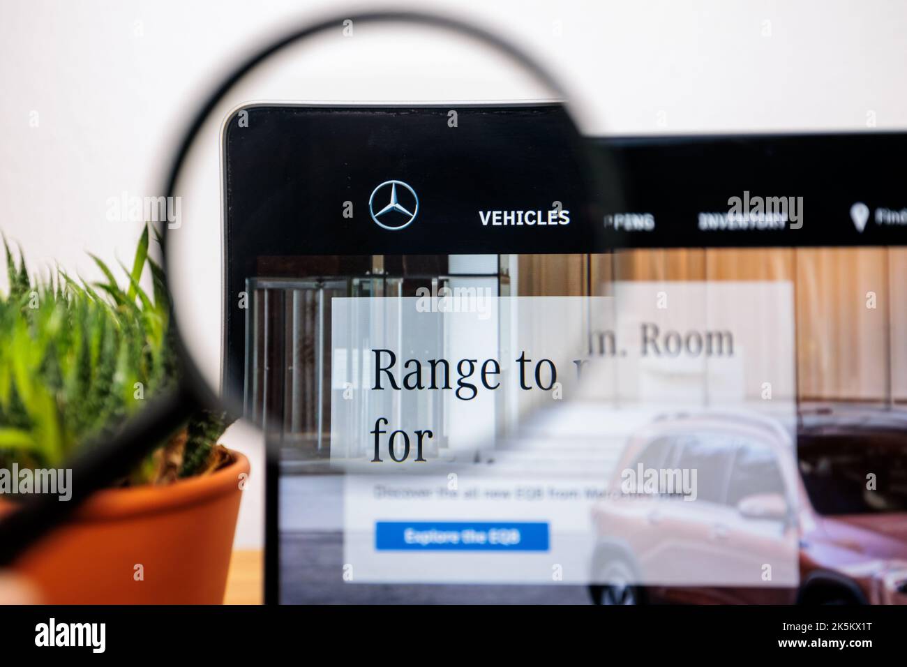 A display of the Mercedes website on a laptop screen and the Mercedes ...