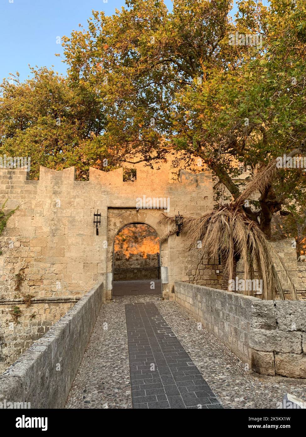 The vertical view of a medieval palace entrance under the blue sky ...