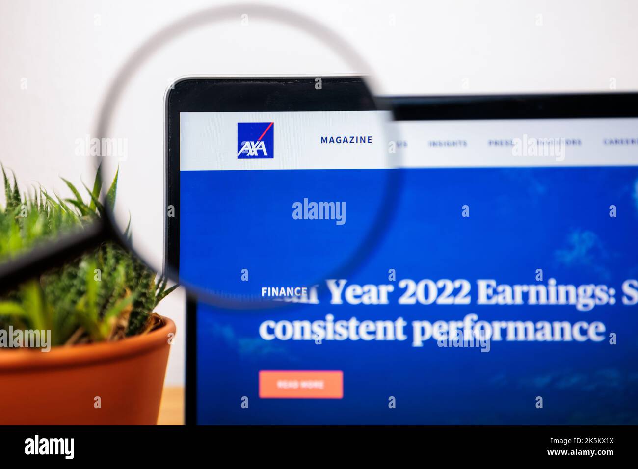 A display of the AXA website on a laptop screen and the AXA logo under ...