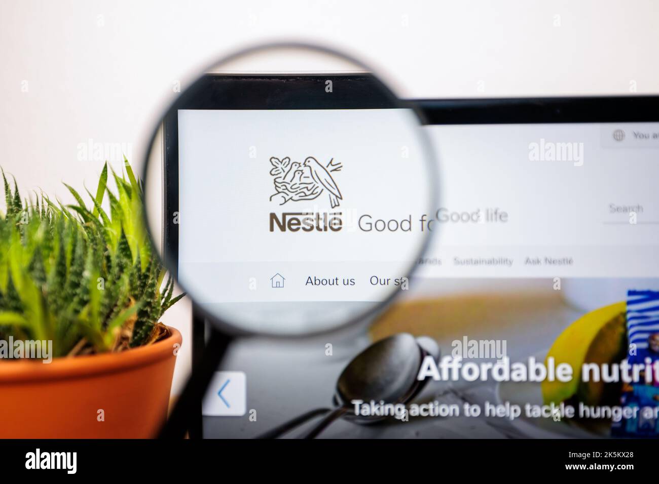 A display of the Nestle website on a laptop screen and the Nestle logo ...
