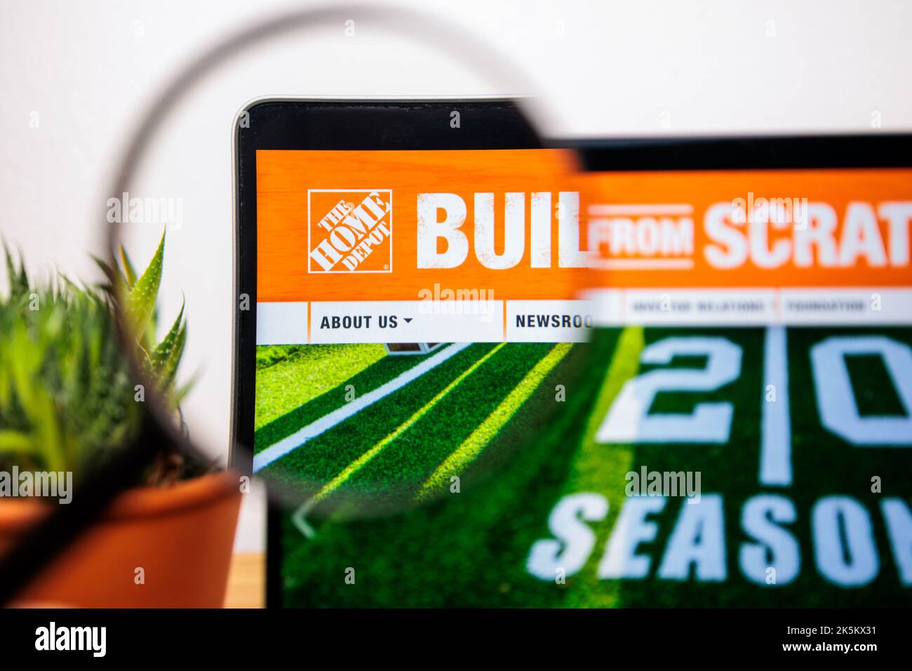 A display of the Home Depot website on a laptop screen and the Samsung ...