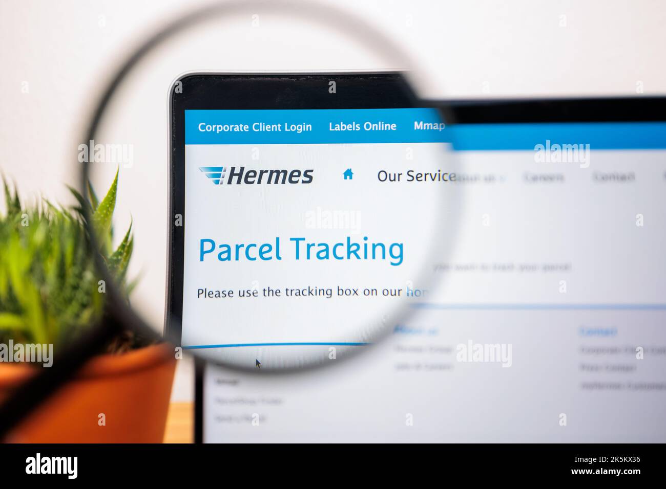 A display of the Hermes website on a laptop screen and the Hermes logo ...