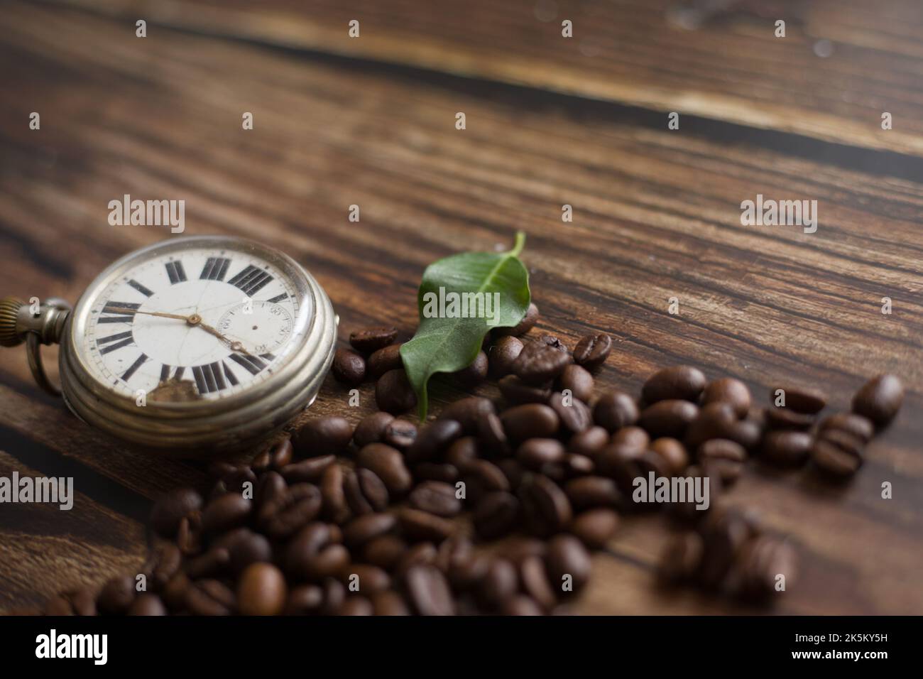 Very old pocket watch on table with roasted coffee beans Stock Photo ...