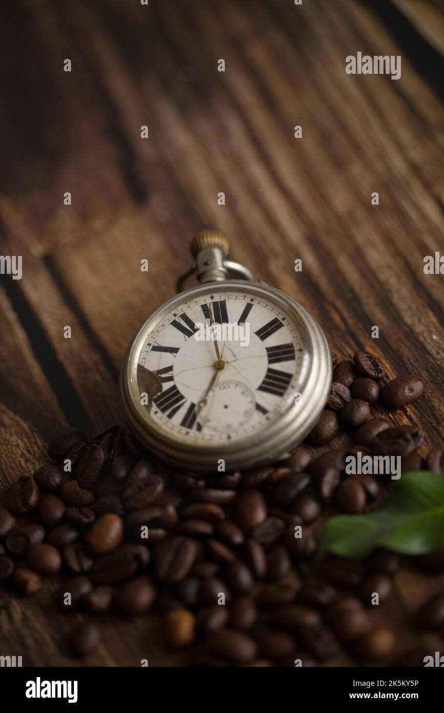 Very old pocket watch on table with roasted coffee beans Stock Photo ...