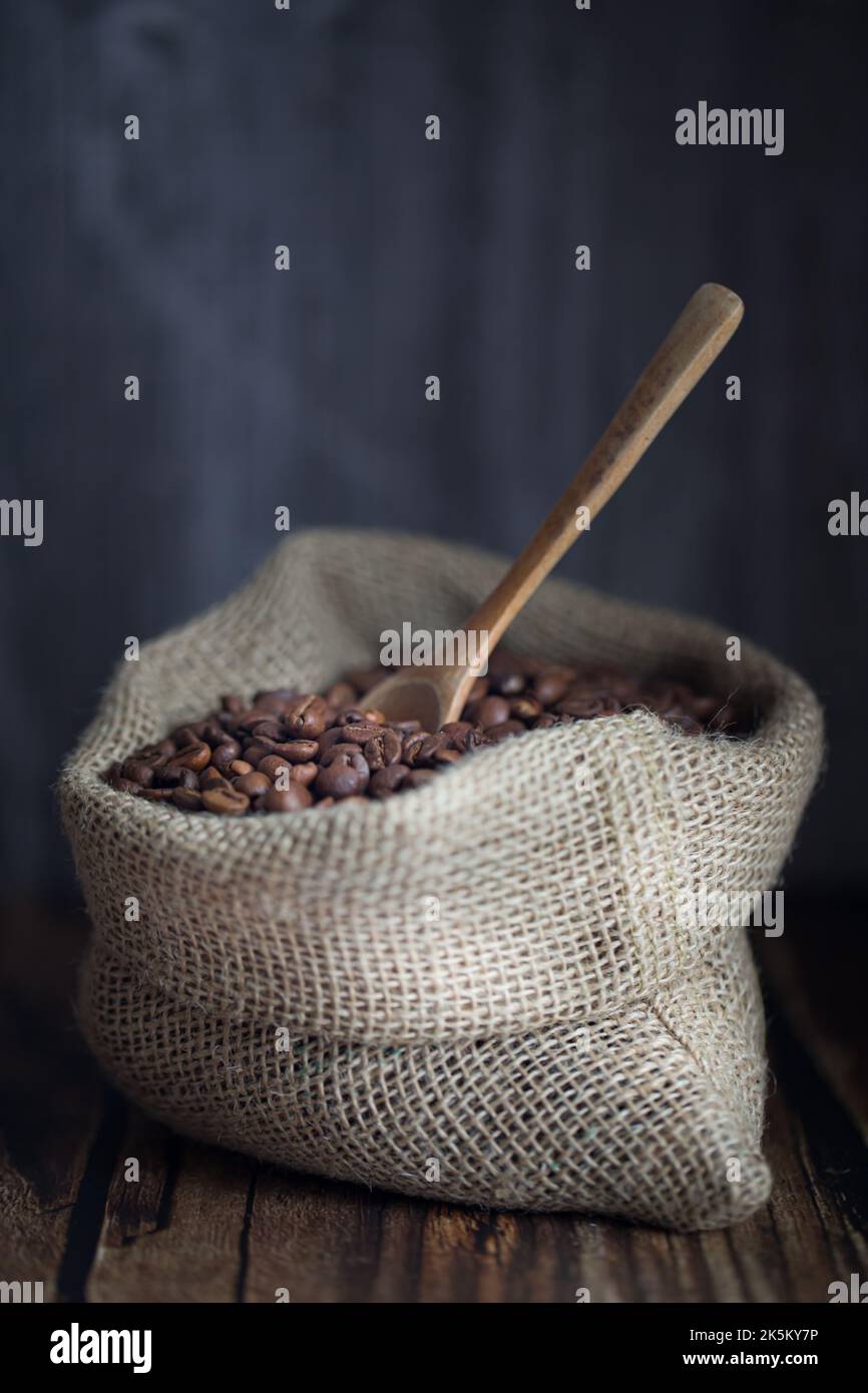 Coffee beans in jute bag-sack and wooden spoon on table Stock Photo - Alamy