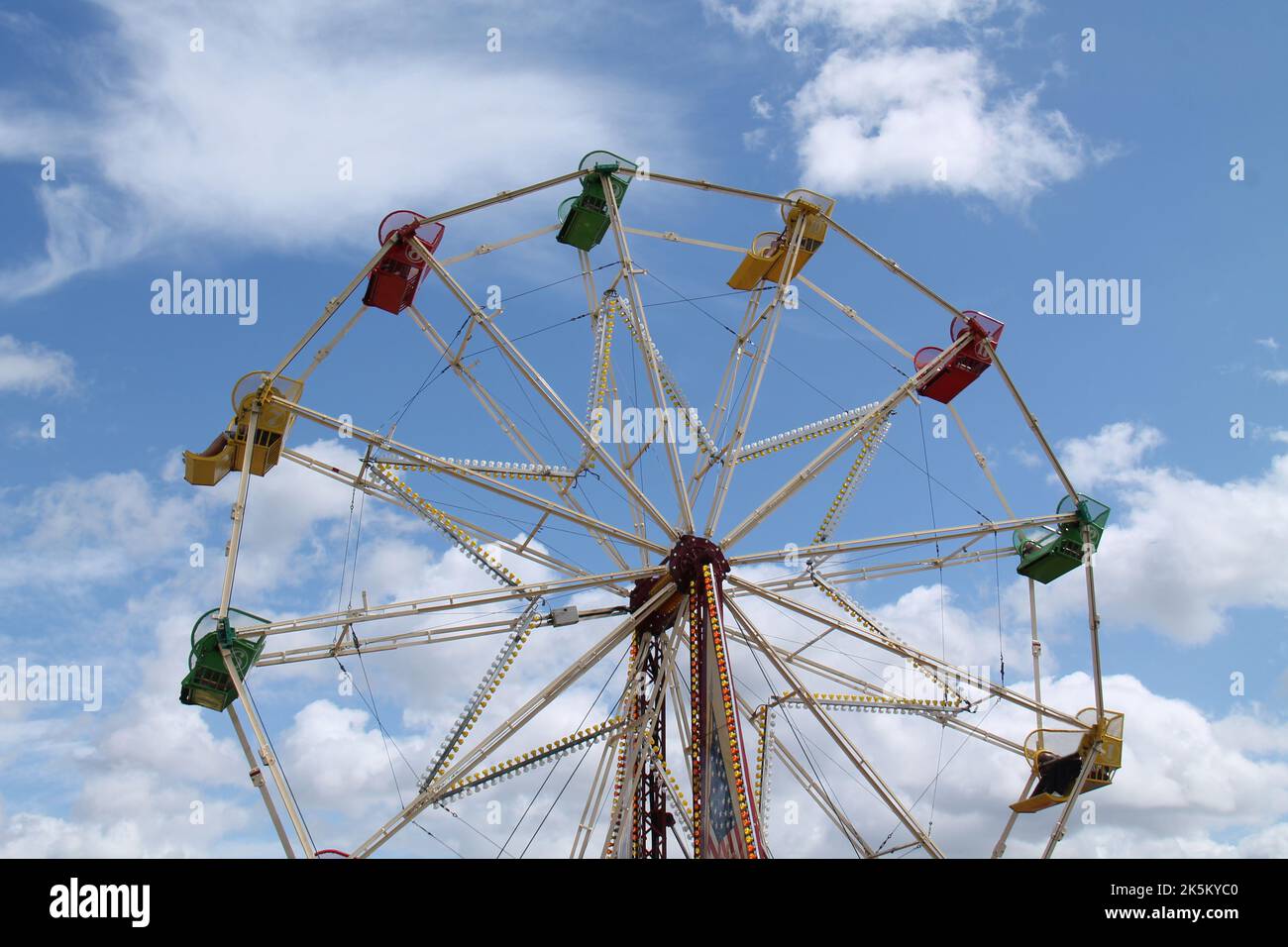 The Riding Carriages on an Old Style Big Wheel Ride Stock Photo - Alamy