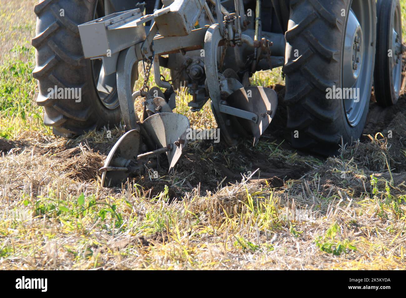 A Small Agricultural Plough on the Back of a Vintage Tractor Stock ...