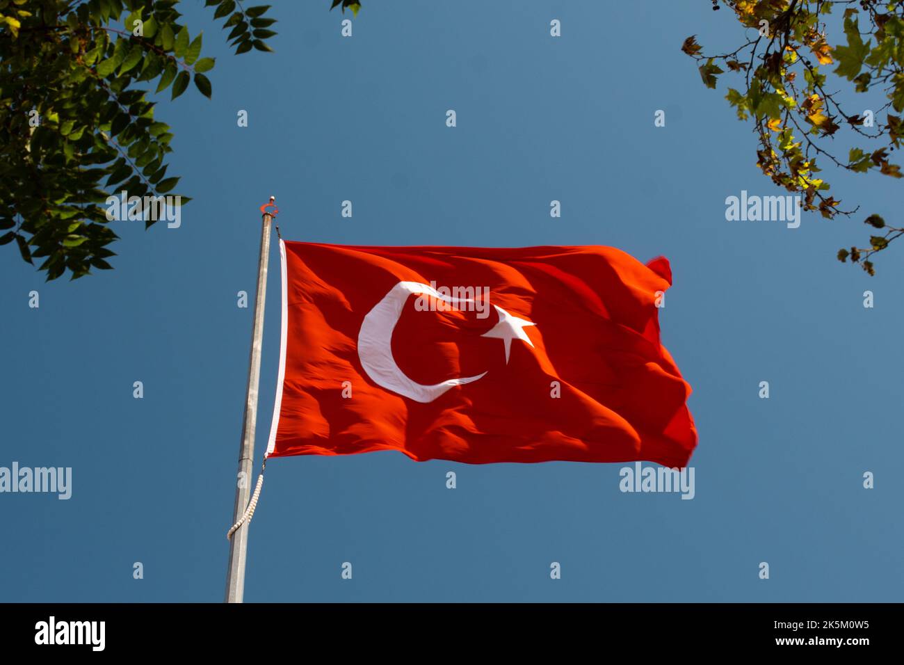 Turkish national flag with white star and moon on a pole in sky Stock ...