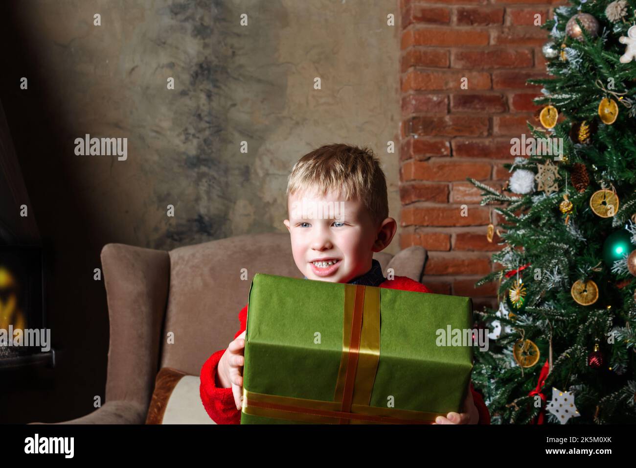 Happy caucasian boy holding present in hand Stock Photo - Alamy