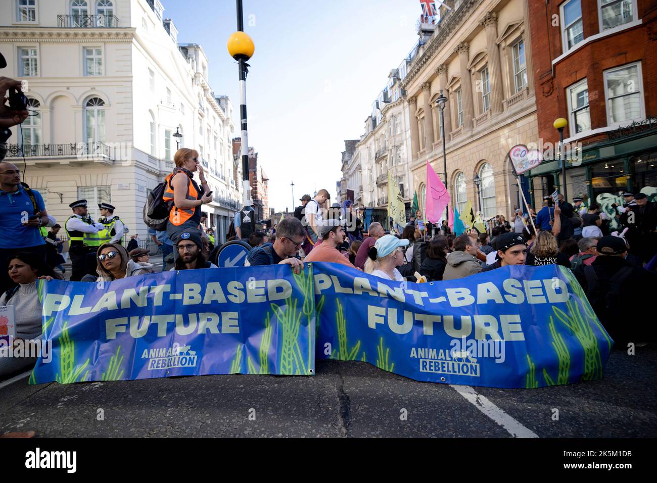 London, UK. 08th Oct, 2022. Activists seen sitting on the road with ...