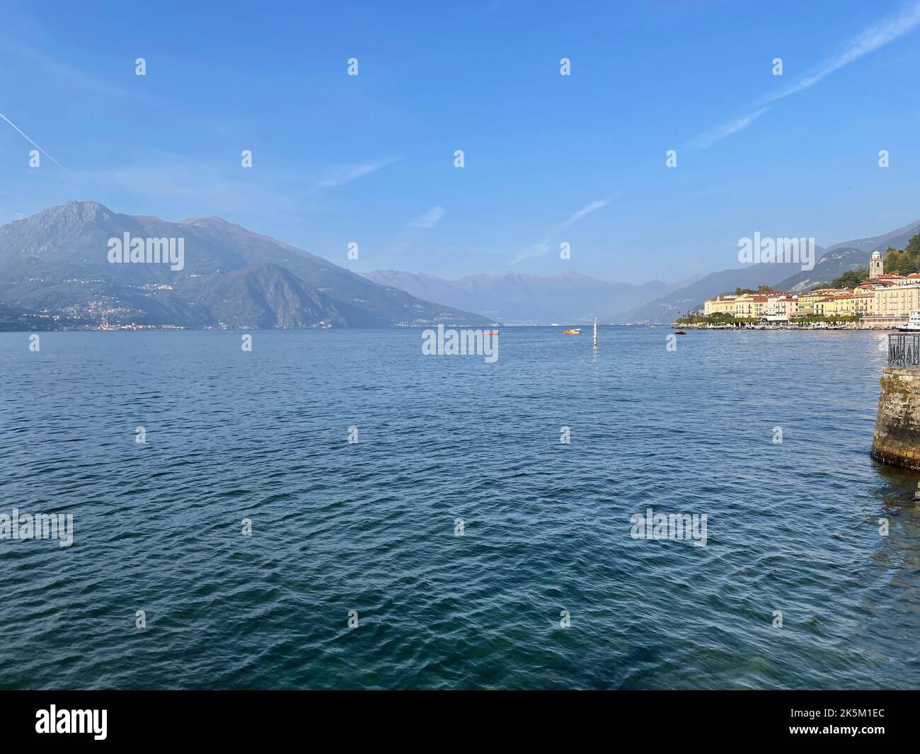 A beautiful shot of Lake Como and mountains around under blue sky in ...