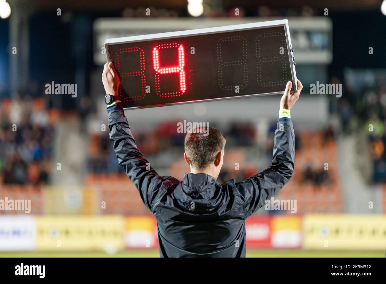 Sideline referee shows 4 minutes added time during the football match ...