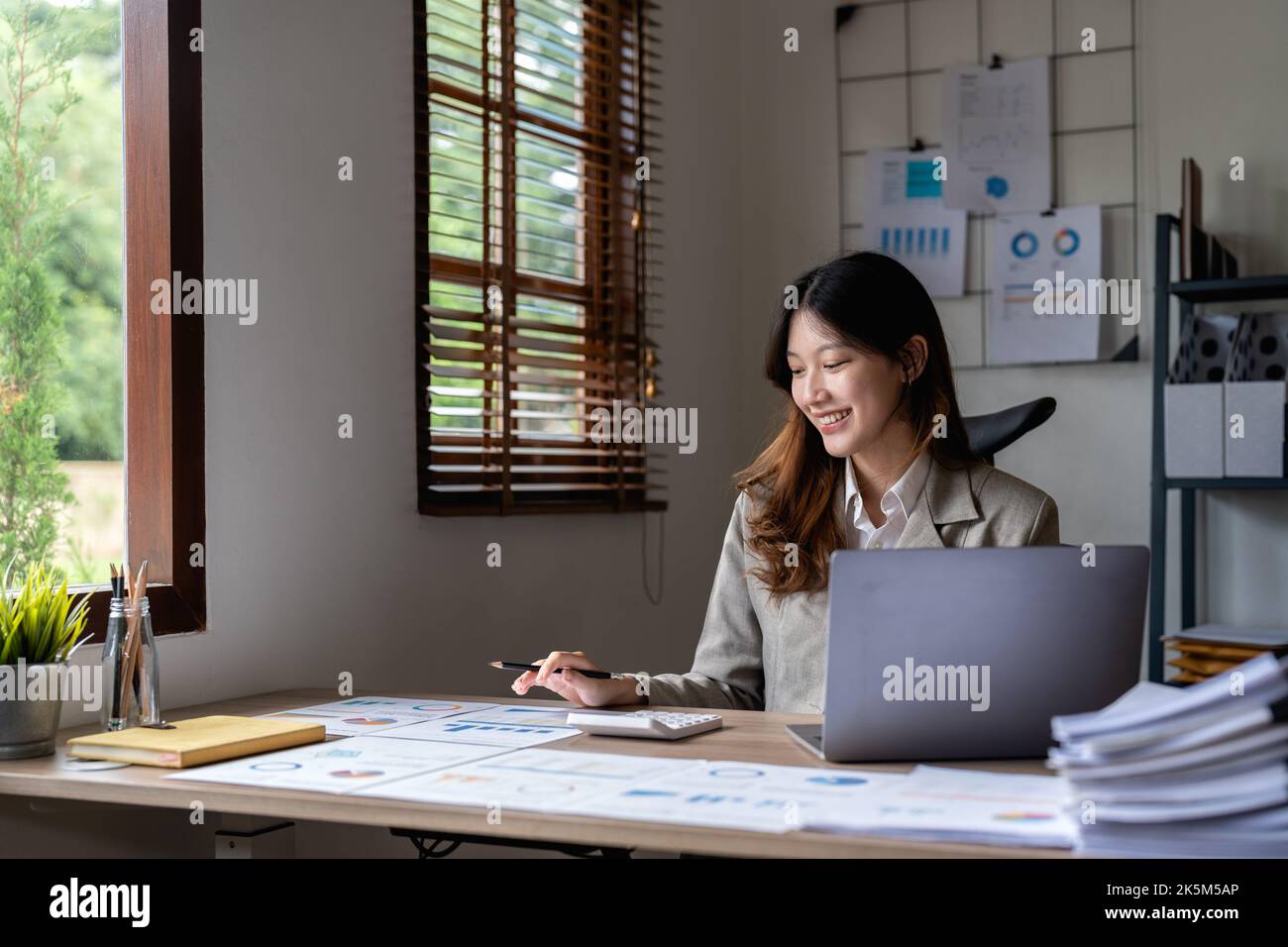 Portrait asian woman accountant working with computer and calculator ...