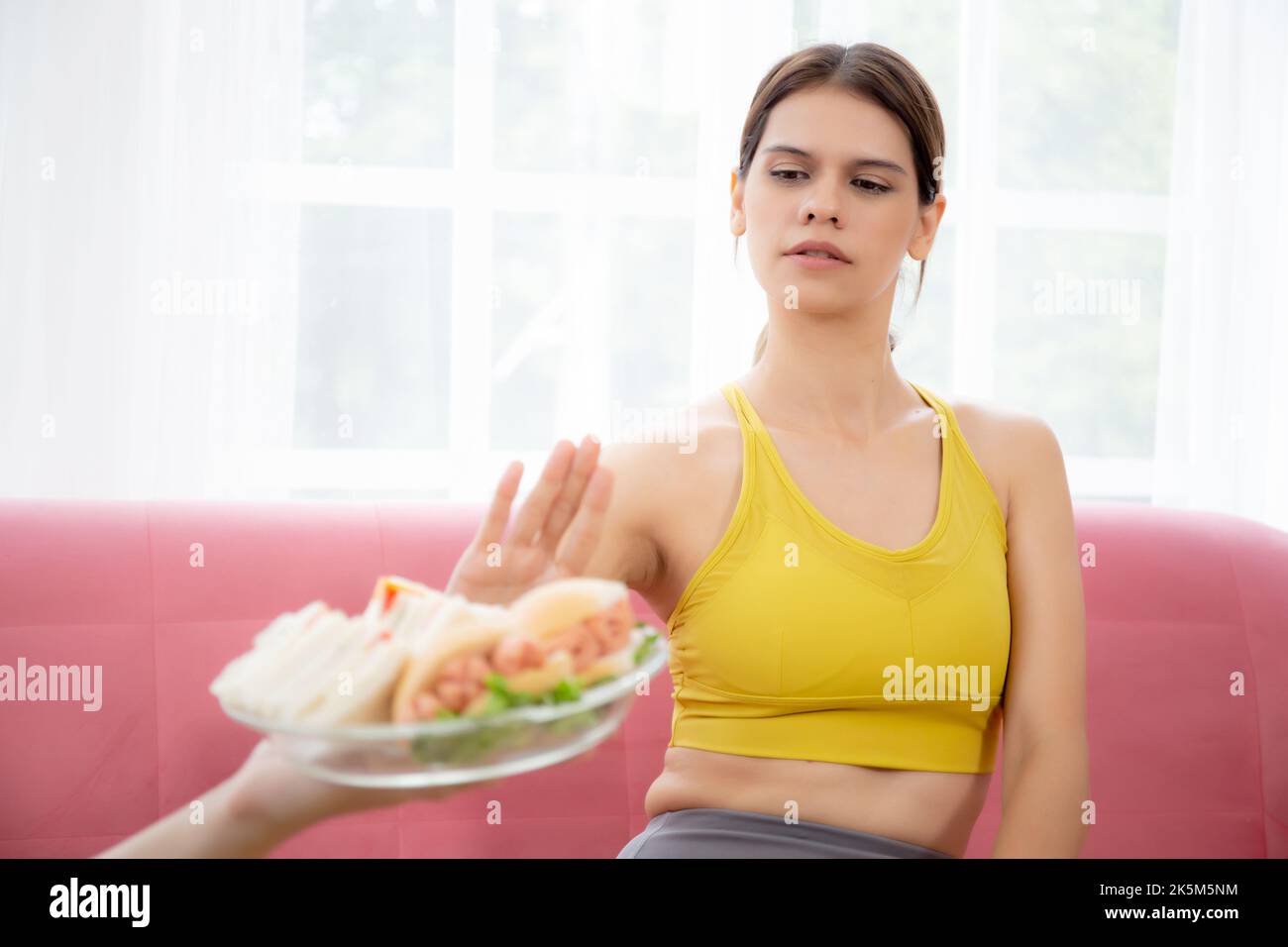 Hands serving food and young caucasian woman making sign say no food ...