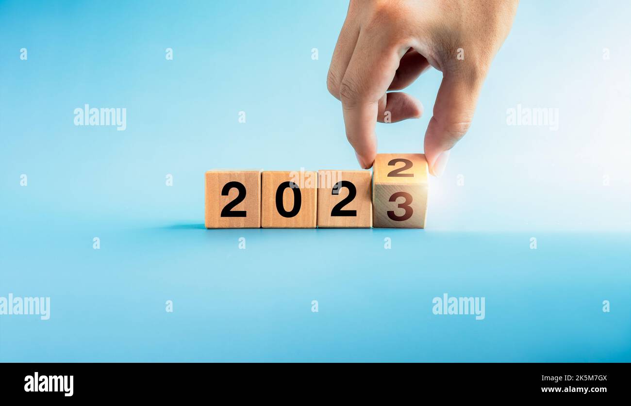 The calendar year 2022 changed to the new year 2022. Close-up hand ...