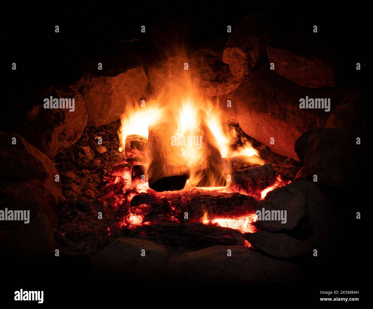 Warm campfire glowing brightly after dusk Stock Photo - Alamy