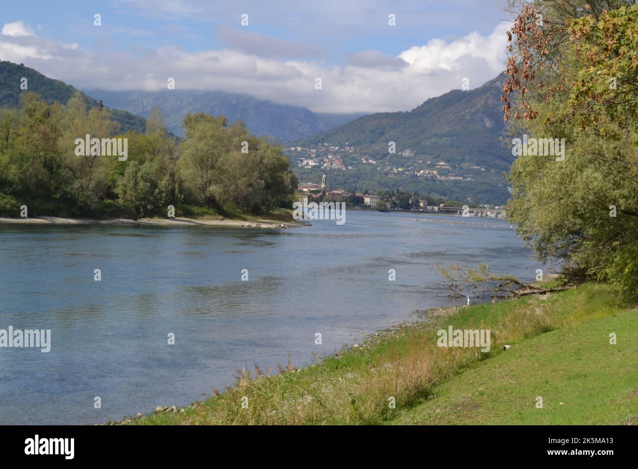 Beautiful summer landscape of the river Adda wide course with mountains ...