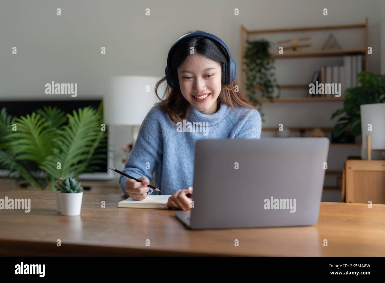Smiling girl student wear headphone study online with teacher, happy ...