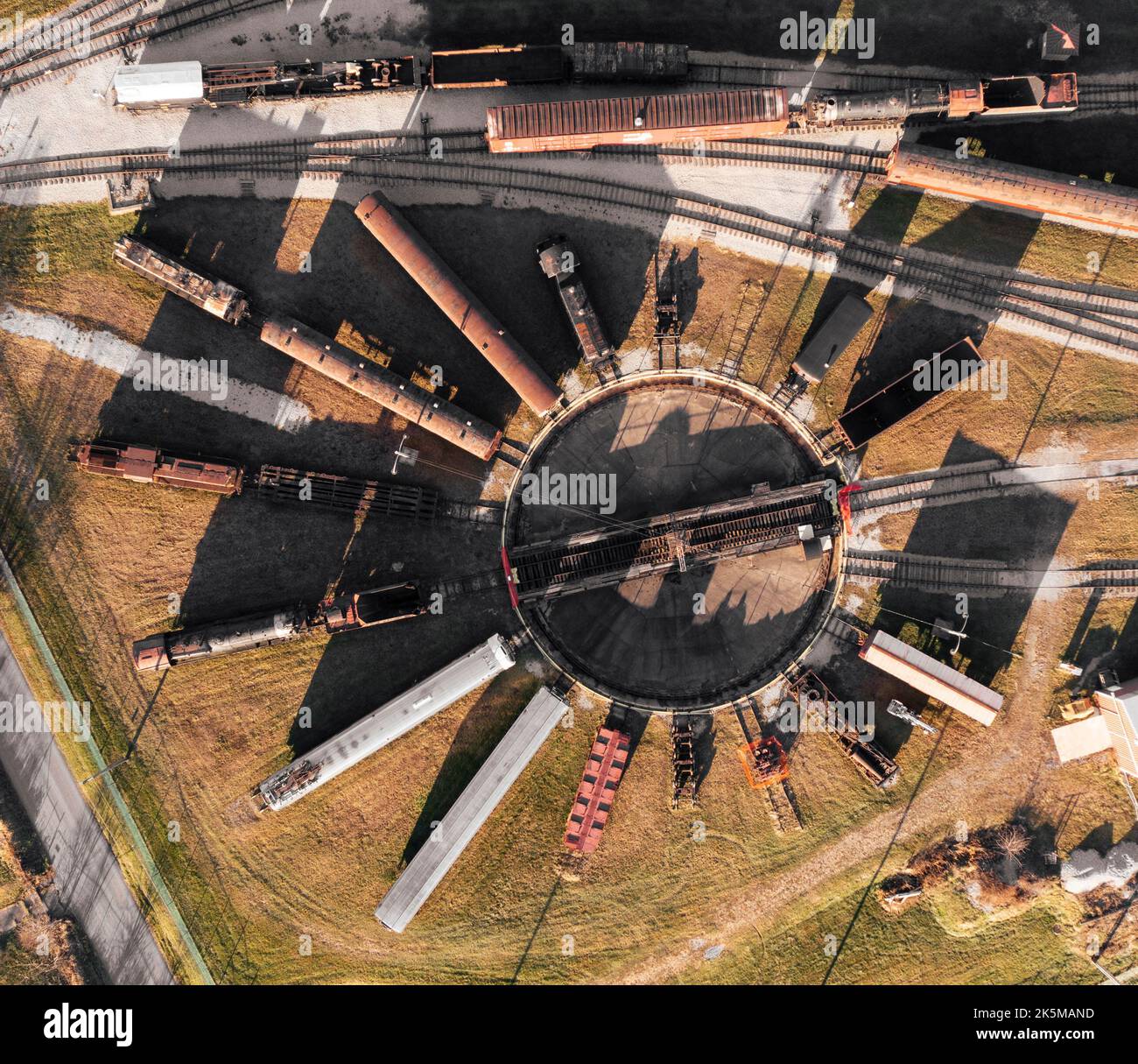 An aerial top view of a railroad turntable with trains on the tracks on ...