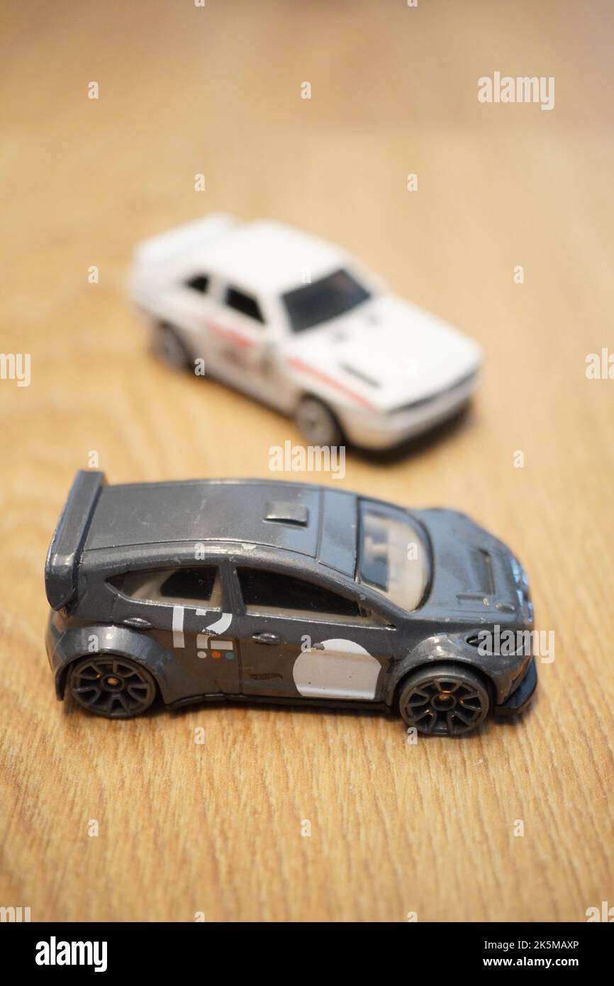 A vertical high-angle closeup of a Hot Wheels gray race car toy with a ...